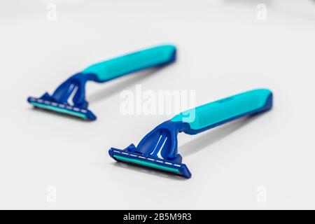 Two disposable razors against white background, close up Stock Photo ...