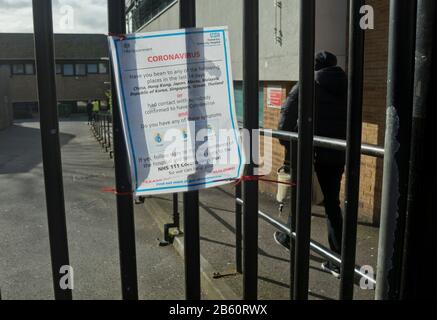 Visitors walk past signs to Coronavirus pod at Homerton NHS hospital in ...