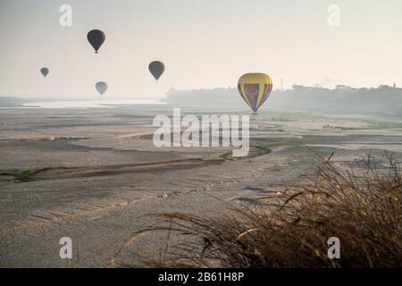 Bagans temples in sunrise with hot air balloons in the sky, Bagan ...