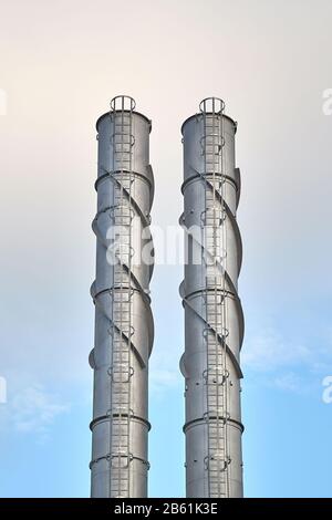 Old industrial building with two chimneys among trees Stock Photo - Alamy
