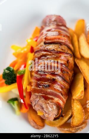 Pork fillet wrapped in bacon, isolated on white background Stock Photo ...