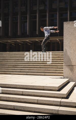 Parkour athlete jumping from the wall and flying. Man practicing ...