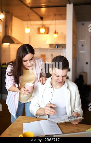 Young man husband in budget planning concept Stock Photo - Alamy