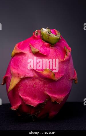 Red pomegranate fruit on magenta color background Stock Photo - Alamy