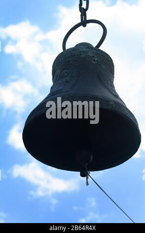 Large Church bell hanging outside. Close-up view of metal orthodox ...