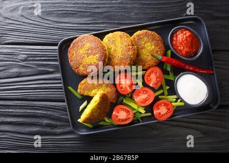 Traditional food Burma Baya Kyaw Yellow pea fritters with sauces close ...