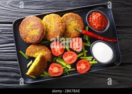 Traditional food Burma Baya Kyaw Yellow pea fritters with sauces close ...