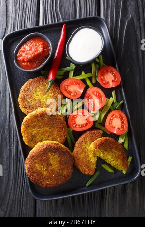 Traditional food Burma Baya Kyaw Yellow pea fritters with sauces close ...