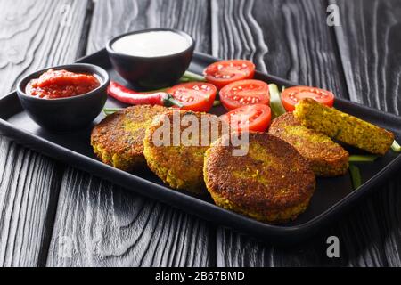 Traditional food Burma Baya Kyaw Yellow pea fritters with sauces close ...