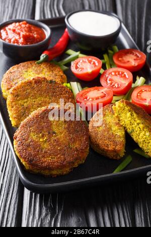 Traditional food Burma Baya Kyaw Yellow pea fritters with sauces close ...
