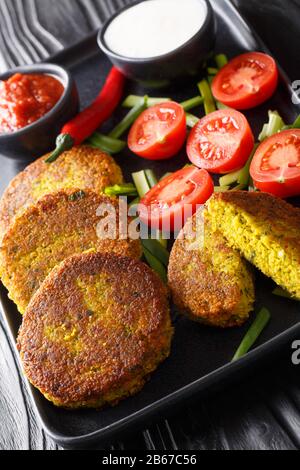 Traditional food Burma Baya Kyaw Yellow pea fritters with sauces close ...