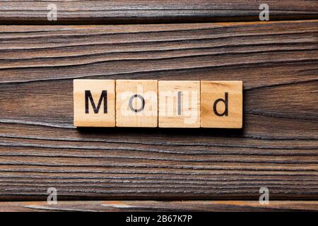 Mold word written on wood block. Mold text on table, concept Stock ...