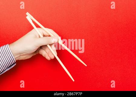 Man ready to eat with pair of chopsticks Stock Photo - Alamy