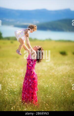 Cuddling with mom. a mother and daughter spending time together at home ...