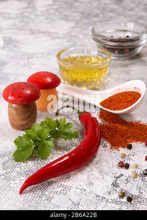 Composition with bowl of chili powder on wooden table Stock Photo - Alamy