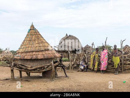 Toposa tribe women in traditional clothing dancing during a ceremony ...