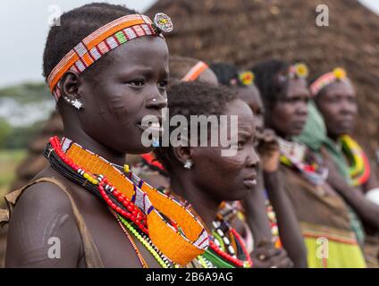 Toposa tribe women in traditional clothing dancing during a ceremony ...