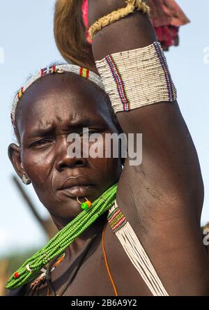 Toposa tribe woman in traditional clothing dancing during a ceremony ...