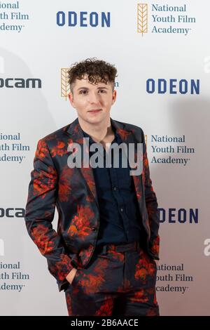 Jamie Carter posing for photos on the red carpet before attending the ...