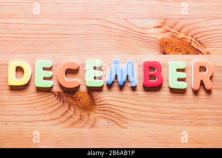 December word written with colorful letters on white marble stone ...