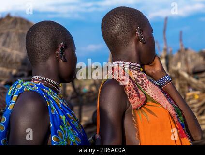 Toposa tribe women in traditional clothing dancing during a ceremony ...