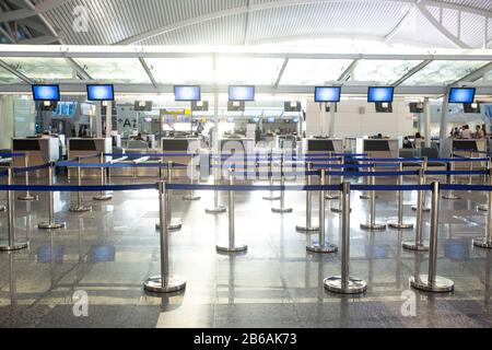 Check in booths and luggage drop off counters in departure hall at ...
