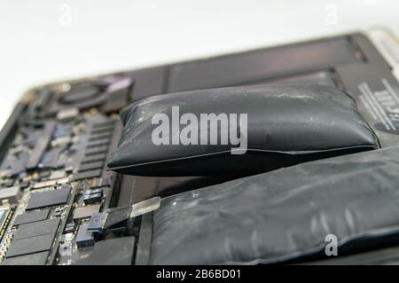 Lithium-ion laptop battery that has swollen Stock Photo - Alamy