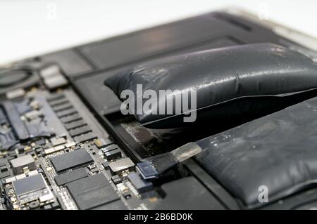Lithium-ion laptop battery that has swollen Stock Photo - Alamy