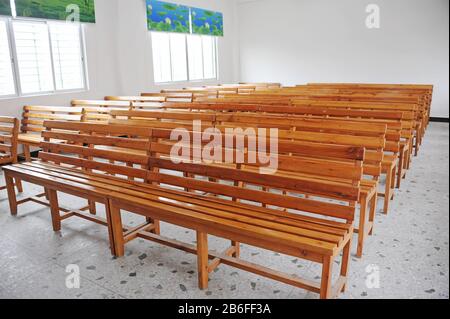 Empty benches in classroom at school Stock Photo - Alamy
