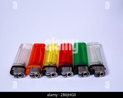 six lighters in different colors lying on white underground Stock Photo ...