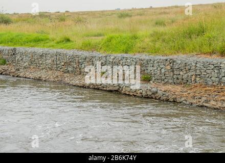 Gabion retaining walls to control erosion and flooding on the banks of ...
