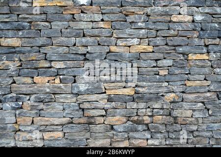 Wall stonework finishing from colorful natural stone blocks trim as ...