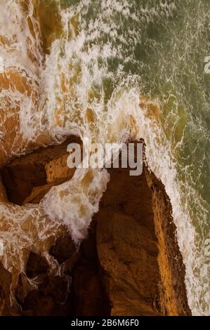 Waves crash over and around rocks in the Caribbean Sea, as seen from ...