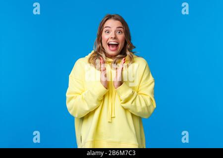 Wow thats awesome. Imrpessed and happy cheerful blond girl clap hands ...