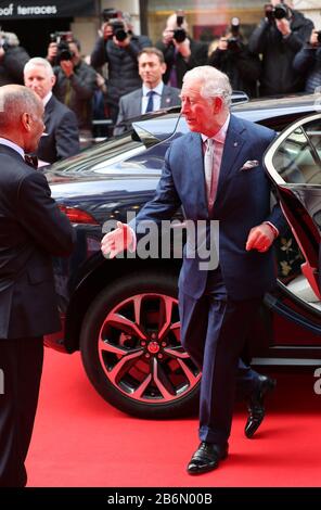 The Prince of Wales goes to shake the hand of Sir Kenneth Olisa, The ...
