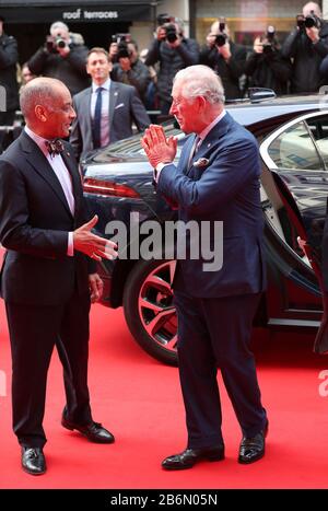 The Prince of Wales goes to shake the hand of Sir Kenneth Olisa, The ...