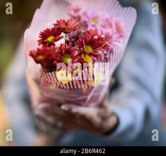 A close up view of gifts provided to Thai monks, candles, a garland and ...