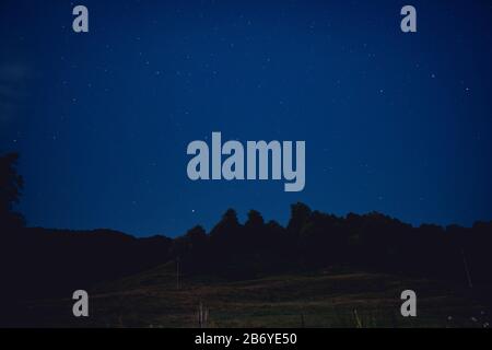Starry night sky over hills Stock Photo - Alamy