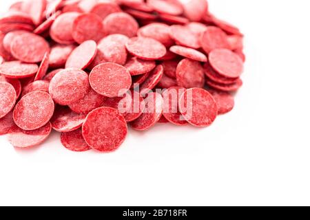 Red round chocolate chips for melting chocolate shapes on a white ...