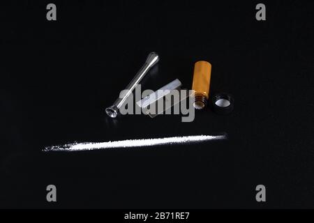 Cocaine on a Black Background, Cocaine Bottle Stock Photo - Alamy