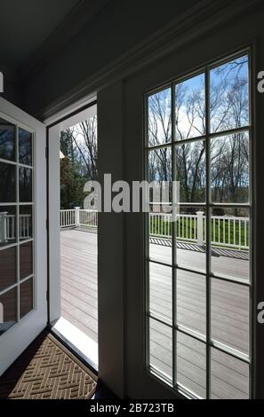 View through window to garden patio with striped awning Stock Photo - Alamy