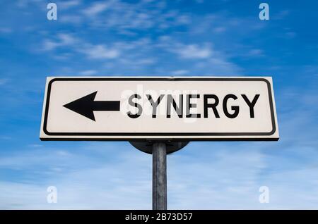 Synergy road sign on blue sky background Stock Photo - Alamy