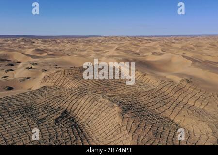 Hanggin Banner. 13th Mar, 2020. Aerial photo shows workers paving sand ...