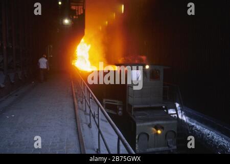 Burning coke falls from the coke oven into the fire engine at the ...
