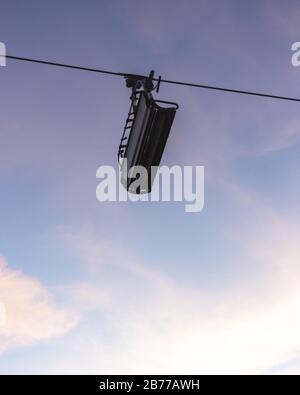 A vertical shot of a winter landscape with a ropeway on cloudy sky ...