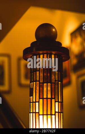 Decorative vintage lamp on top of a table with the light on Stock Photo ...