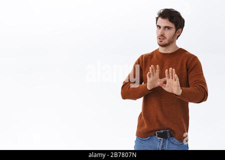 No thank you. Reluctant young man shaking hands, denying smth ...