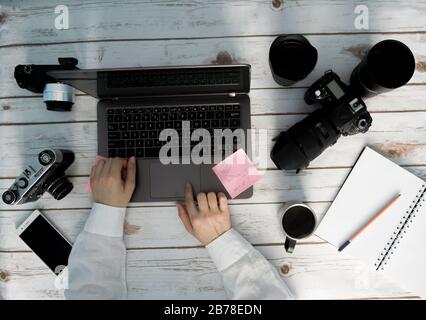 photographer work space - laptop and different cameras Stock Photo - Alamy