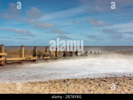 Groin sea defences with craching waves Stock Photo - Alamy