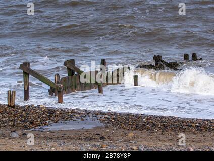 Groin sea defences with craching waves Stock Photo - Alamy